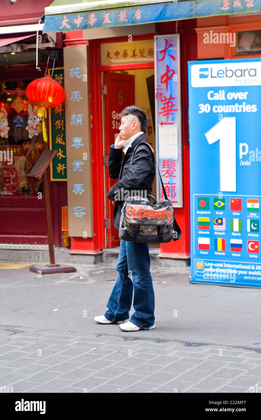 China Town young Asian oriental man mullet haircut mobile cell phone ...