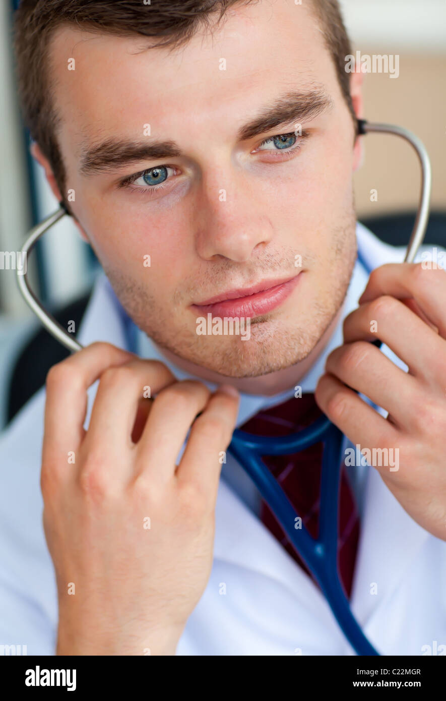 Portrait of an assertive male doctor holding a stethoscope Stock Photo ...
