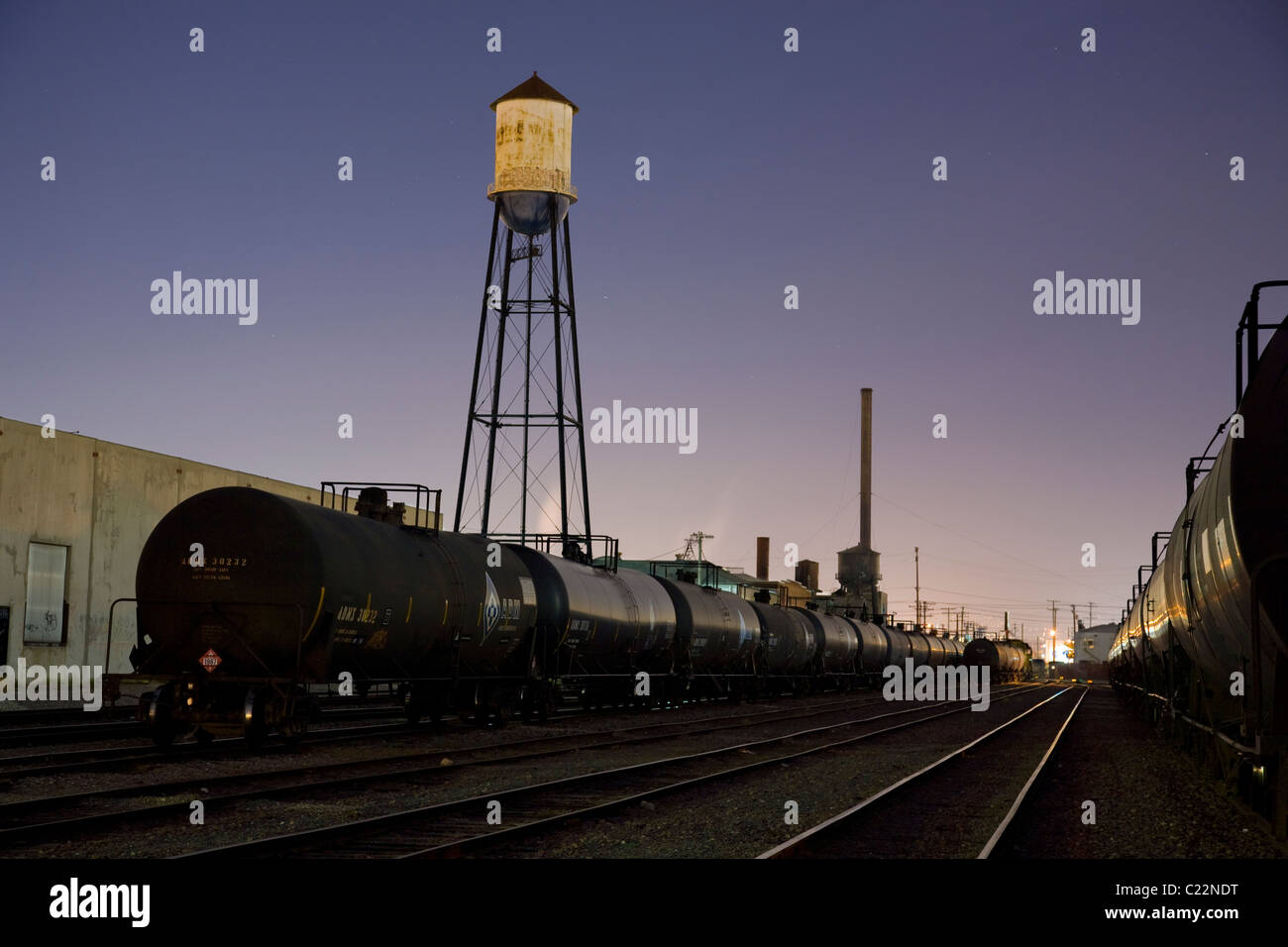 Old Water tower in train yards in Vernon illuminated by moonlight. Los ...