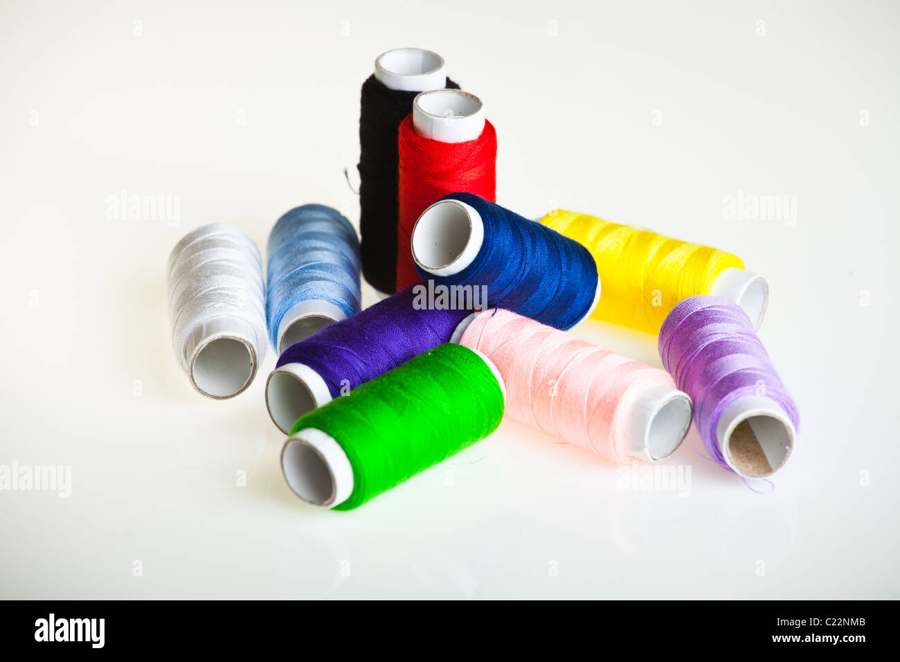 Colorful sewing threads and tools on white isolated background Stock ...