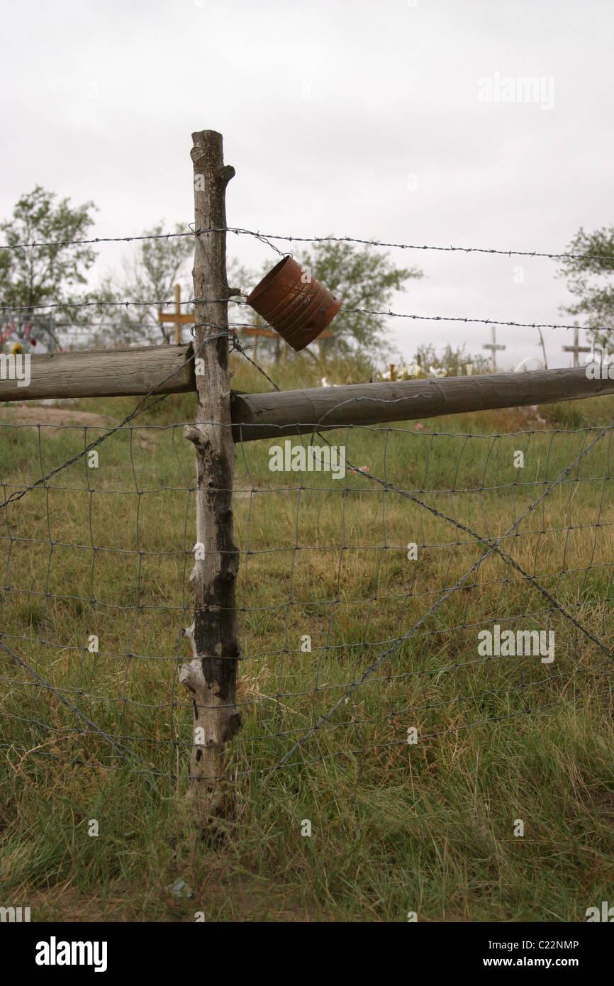Rusted can hanging on a fence post at the Wounded Knee Memorial in ...