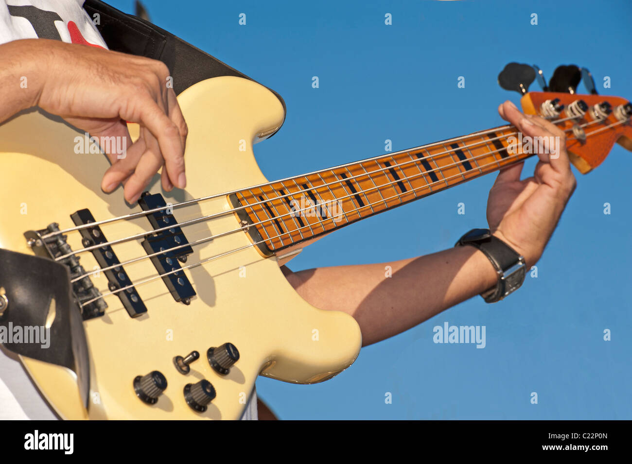 Bass guitarist in a band playing live music Stock Photo - Alamy