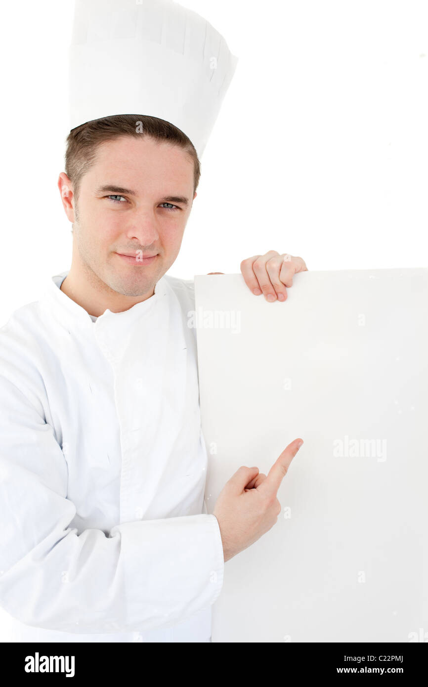 Confident young cook showing on a white paper against white background ...