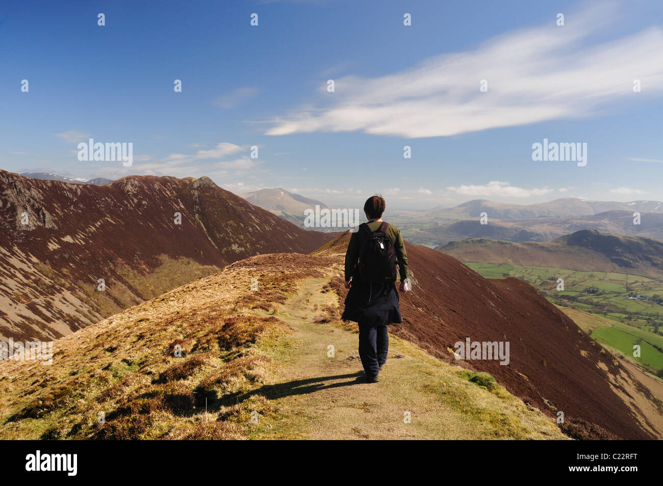Walker on the ridge of Knott Rigg in the English Lake District, looking ...