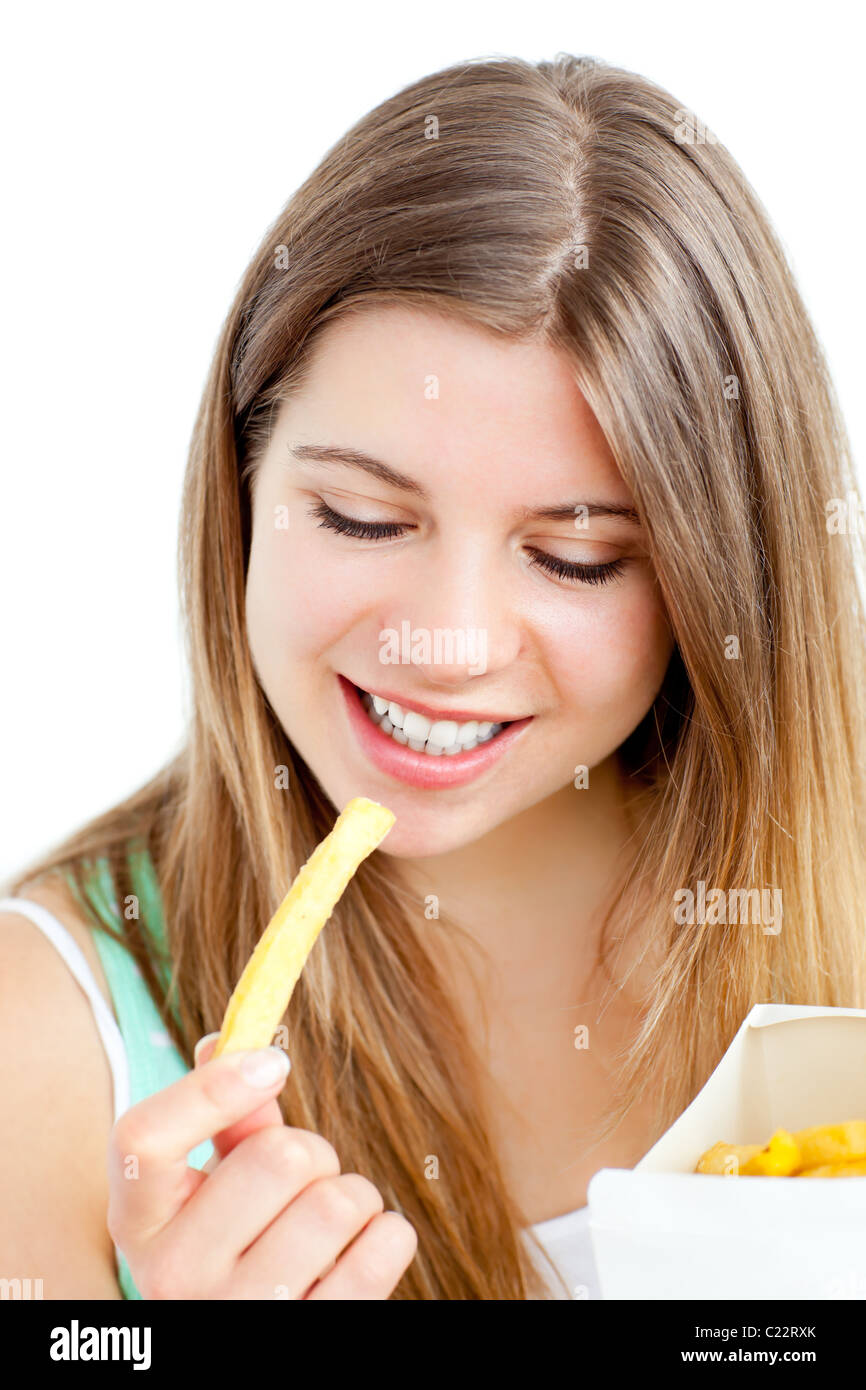 Happy young woman eating fries Stock Photo - Alamy