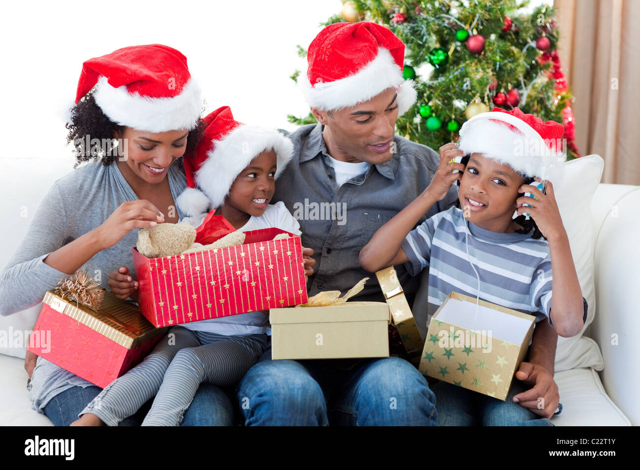 Happy family playing with Christmas presents Stock Photo - Alamy