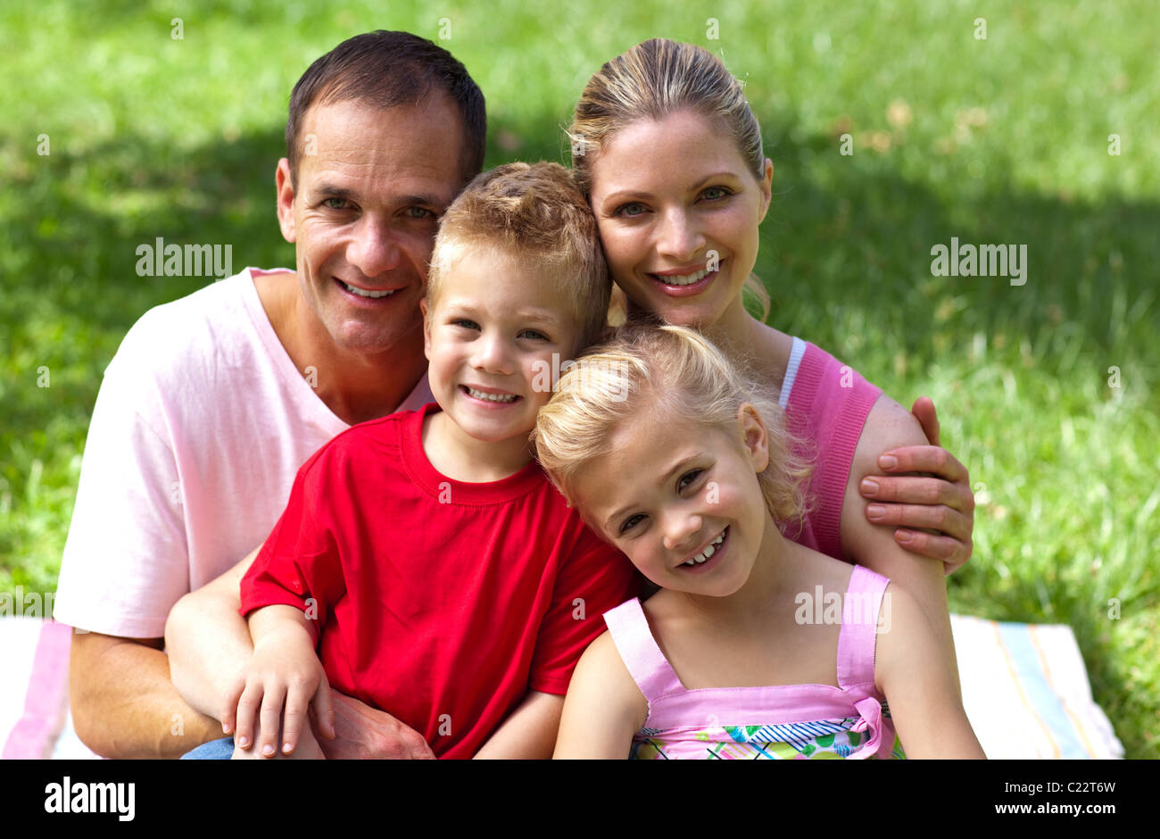 Close-up of a happy family smiling at the camera Stock Photo - Alamy