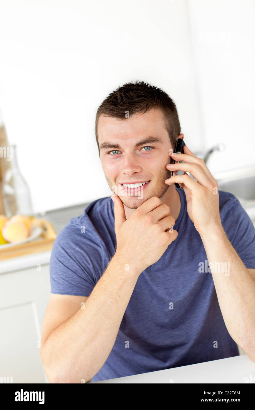 Handsome young man talking on phone and smiling at the camera Stock ...