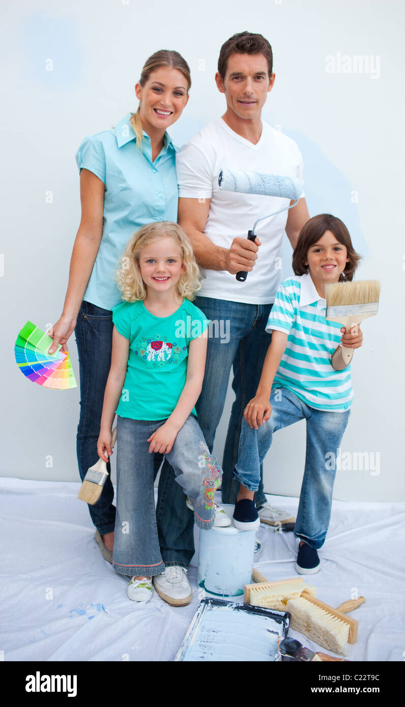 Happy family decorating their new house Stock Photo - Alamy