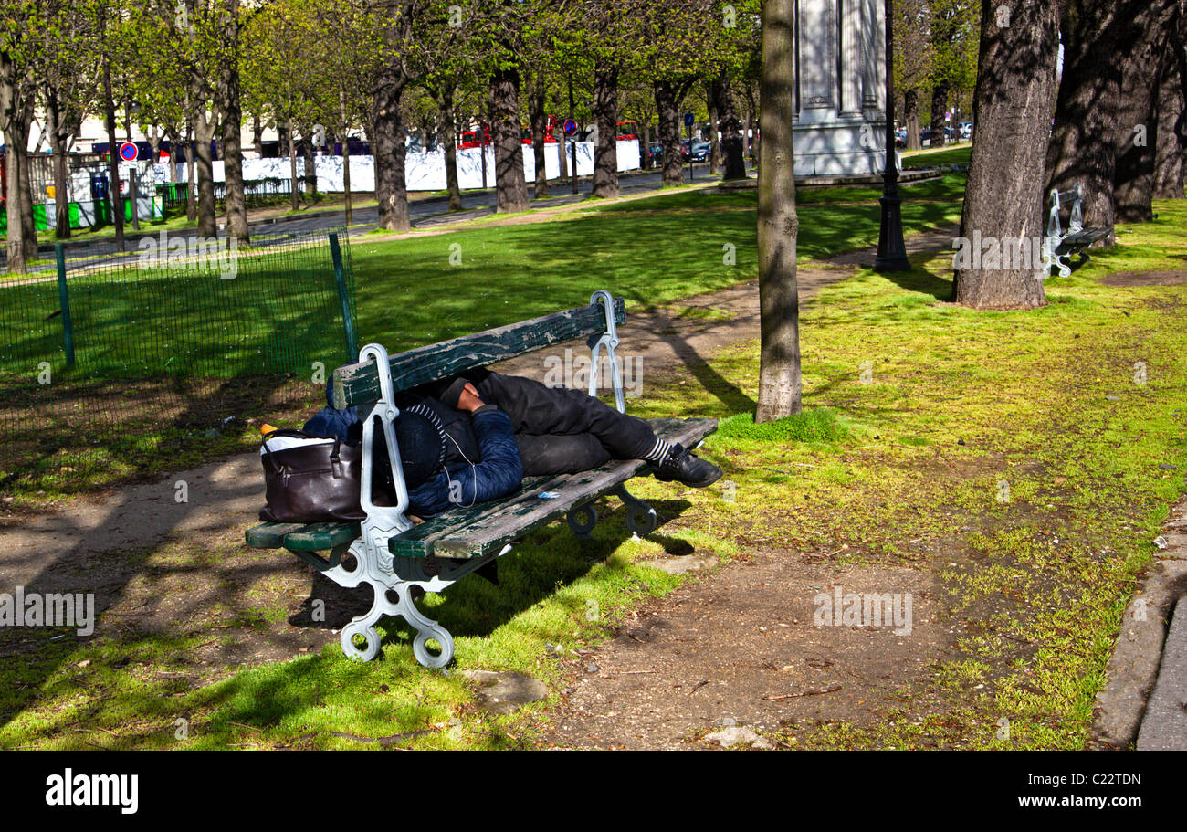 Homeless man sleeping on a park bench; Paris, France, Europe. Charles ...