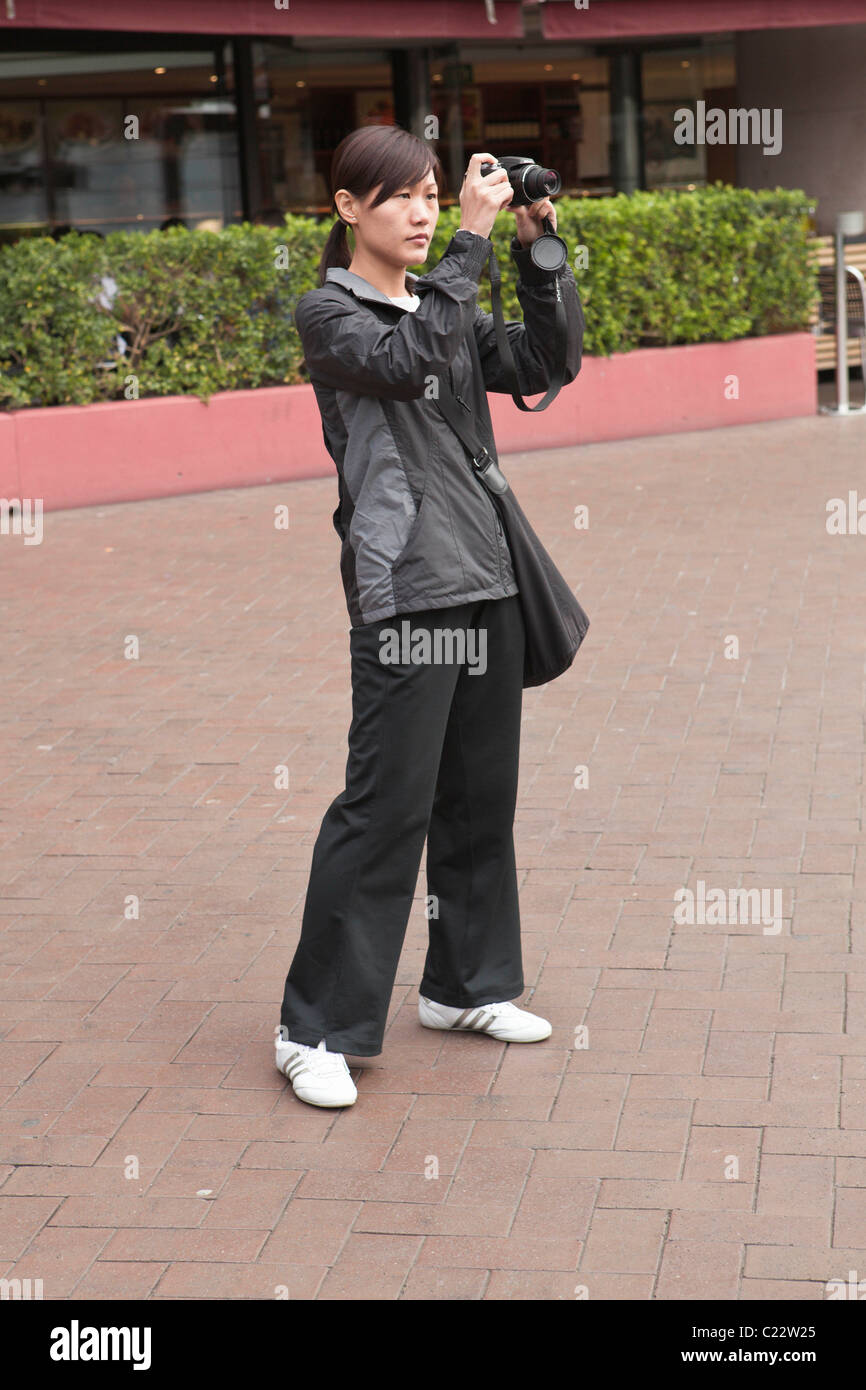 A female tourist photographing a scene Stock Photo - Alamy