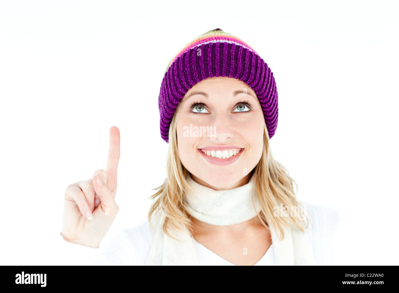 Bright woman with a colorful hat pointing upwards Stock Photo - Alamy