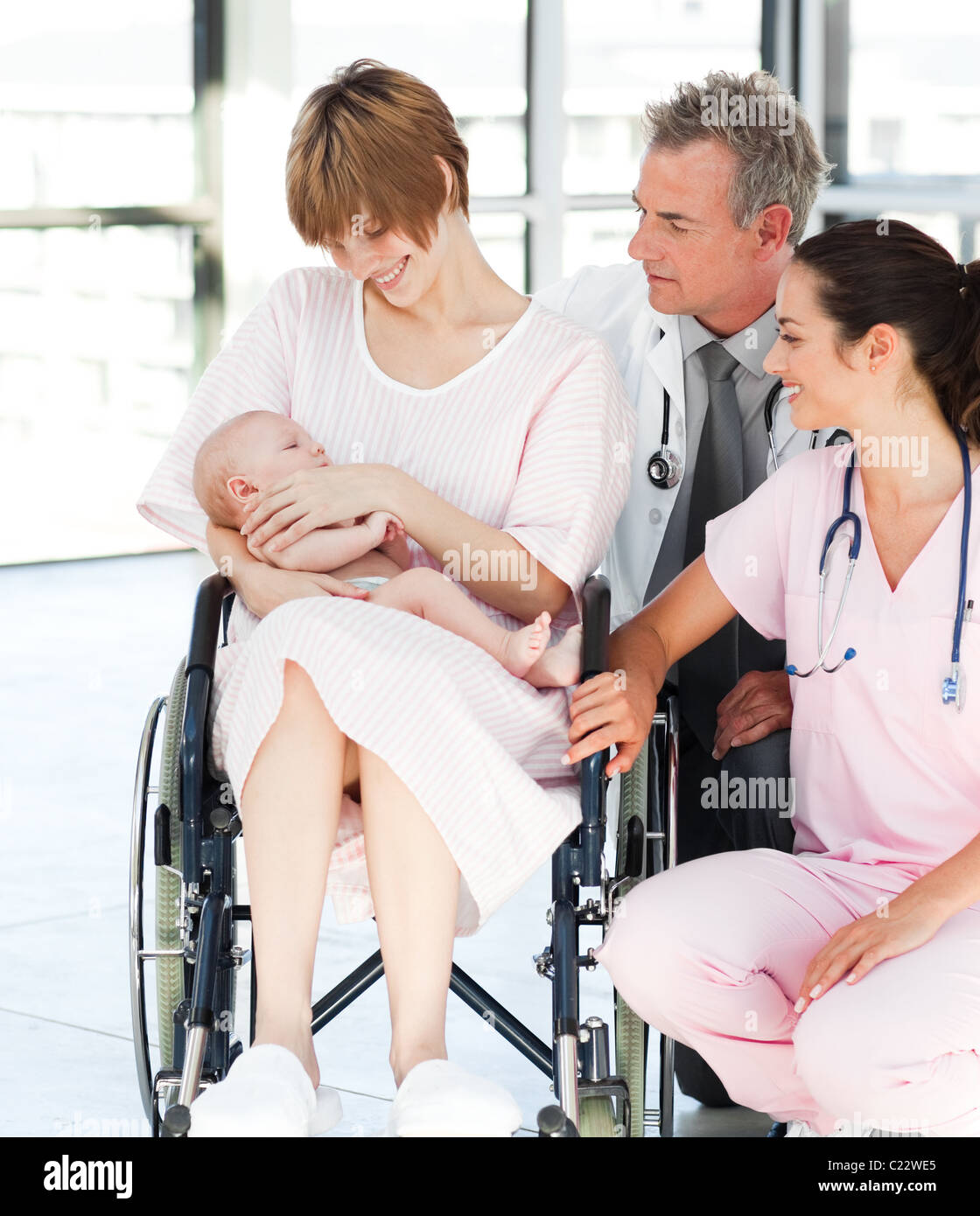 Patient with her newborn baby and doctors Stock Photo - Alamy