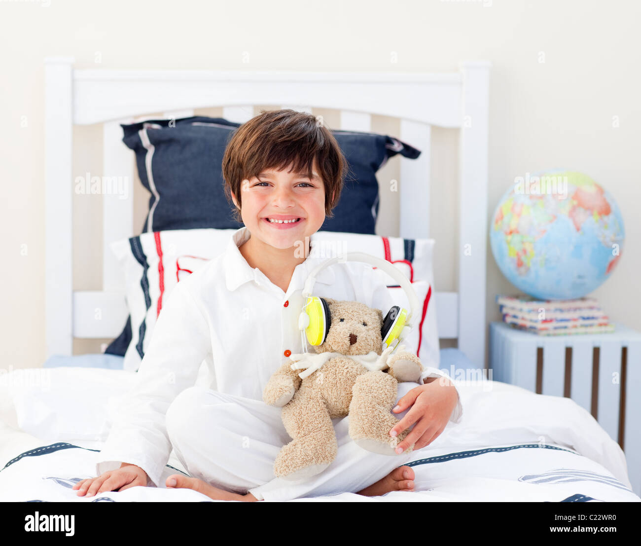 Happy little boy playing with a teddy bear Stock Photo - Alamy