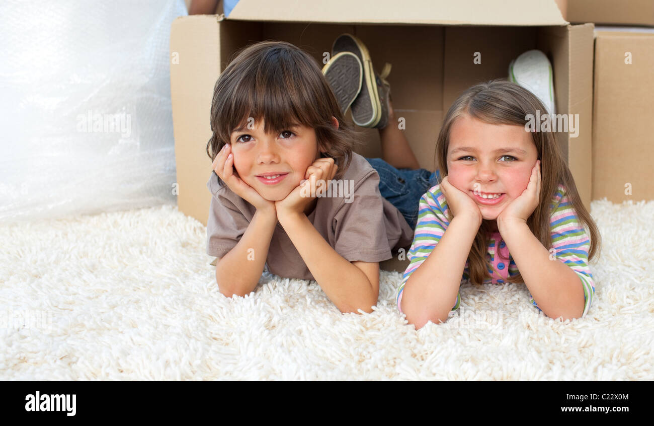 Cute siblings playing with boxes Stock Photo - Alamy