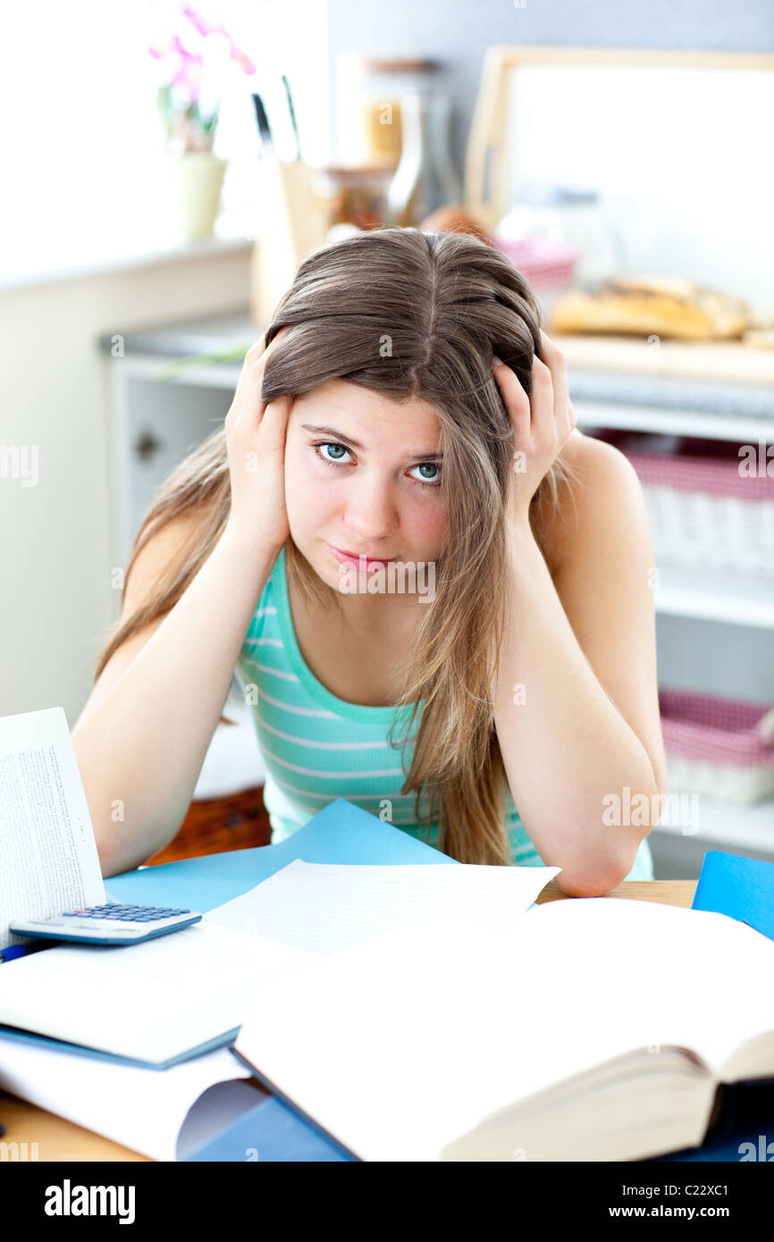 Depressed student doing her homework on a desk Stock Photo - Alamy