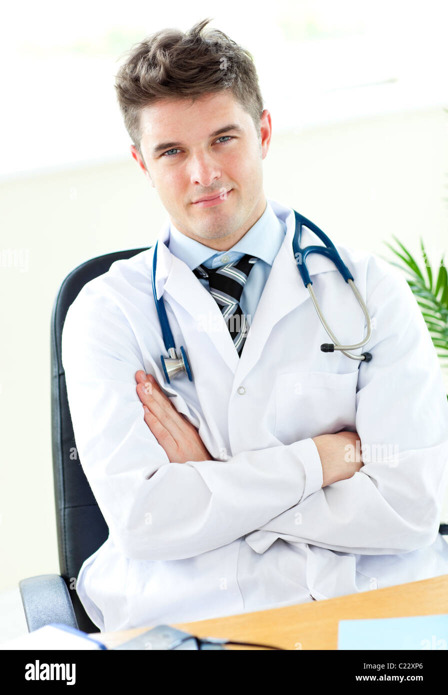 Portrait of a confident male self-assured doctor holding a stethoscope ...
