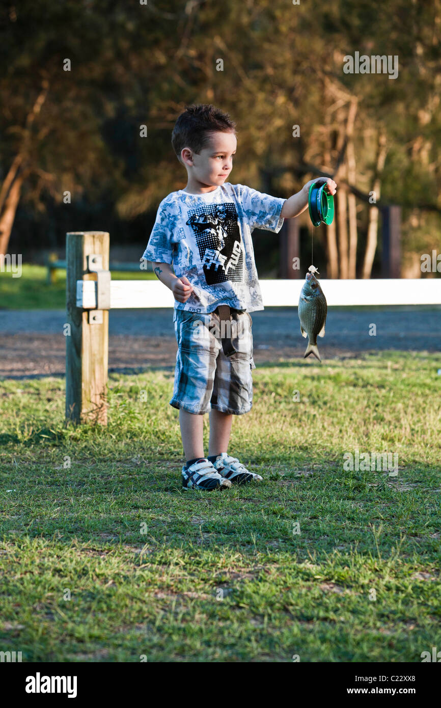A 4 year old boy proudly showing off his first fish Stock Photo - Alamy