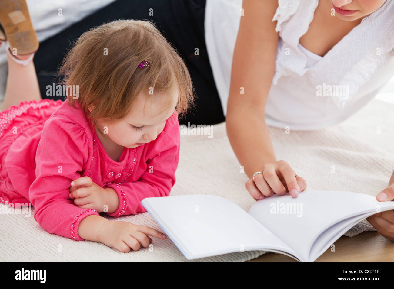 Kind mother reading a book with children Stock Photo - Alamy