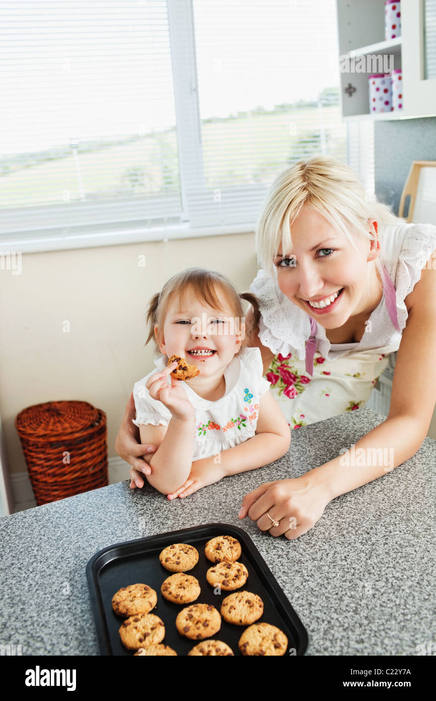 Smiling girl eating cookie Stock Photo - Alamy