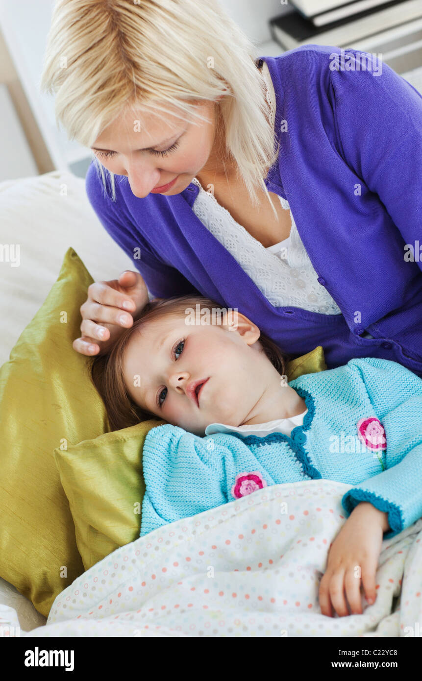 Sick cute child lying on couch Stock Photo - Alamy