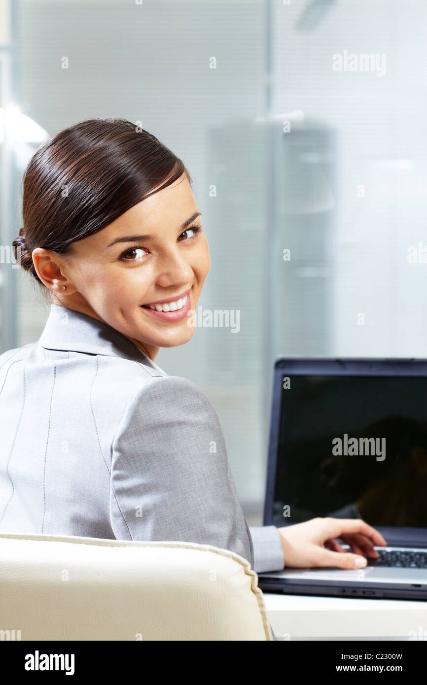 Rear view of young businesswoman doing computer work in office Stock ...
