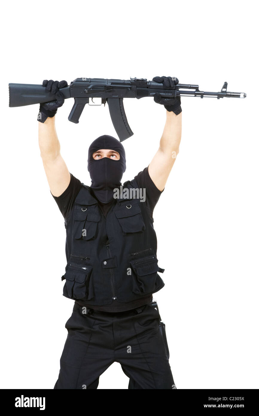 Portrait of armed assassin raising rifle in his hands over white ...