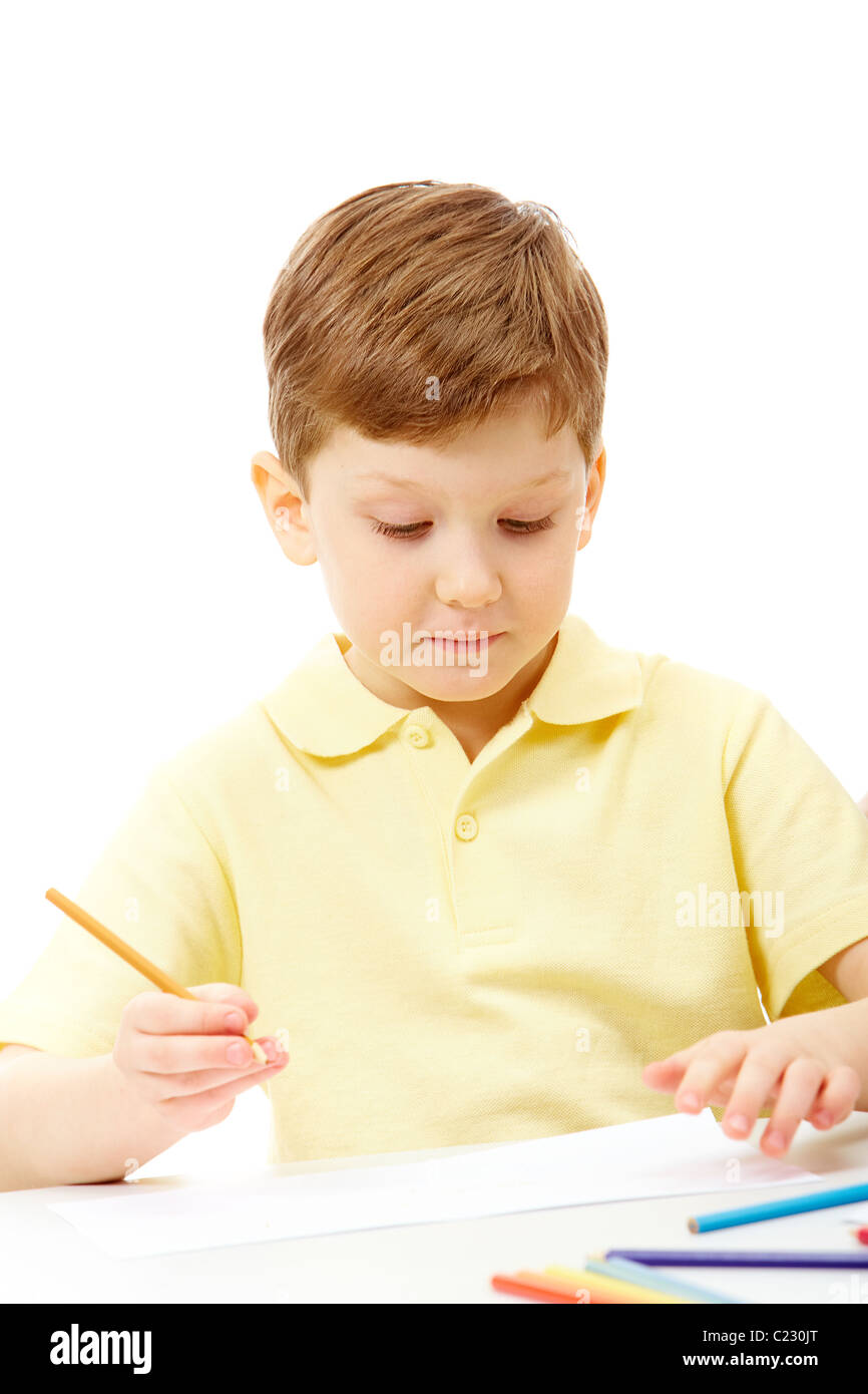 Portrait of young boy holding pencil and looking at the paper Stock Photo - Alamy