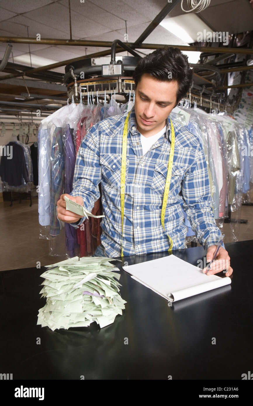 Man working in laundrette hi-res stock photography and images - Alamy
