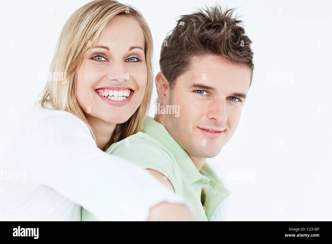 Portrait of a cute woman hugging her boyfriend smiling at the camera Stock Photo - Alamy
