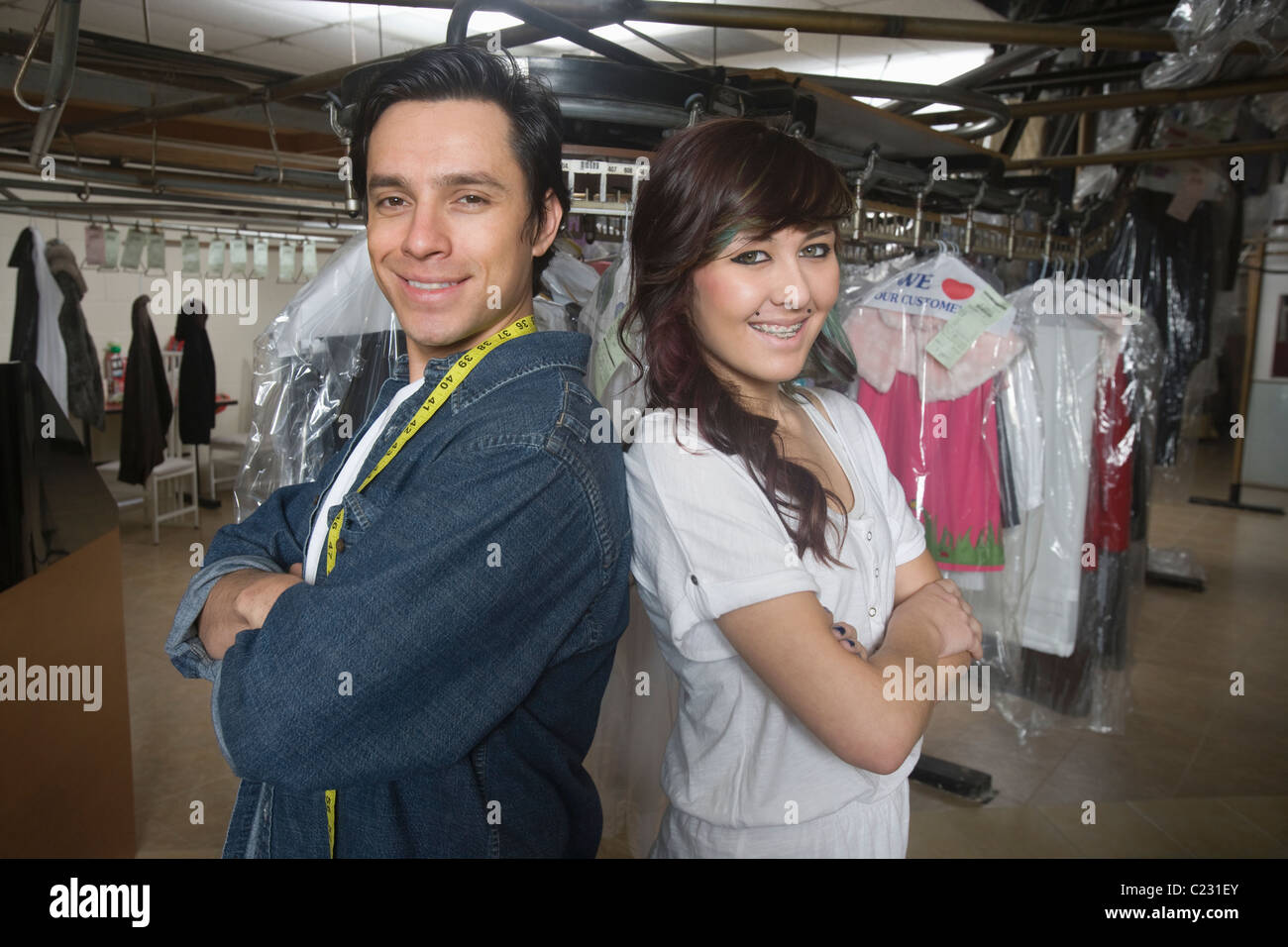 Two people working in laundrette Stock Photo - Alamy