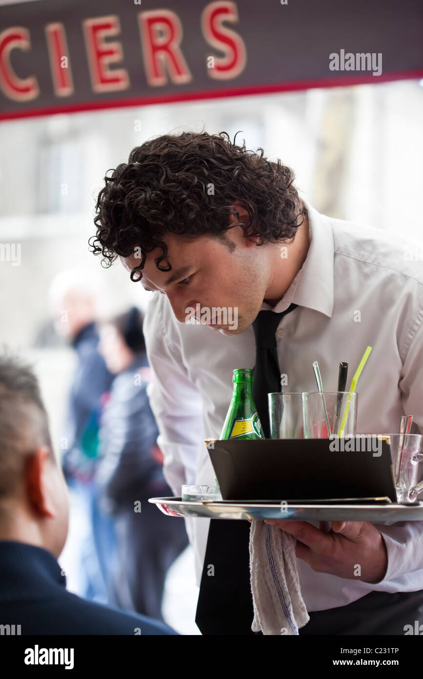 Close up of a Parisian waiter in a Paris sidewalk cafe; Paris, France ...