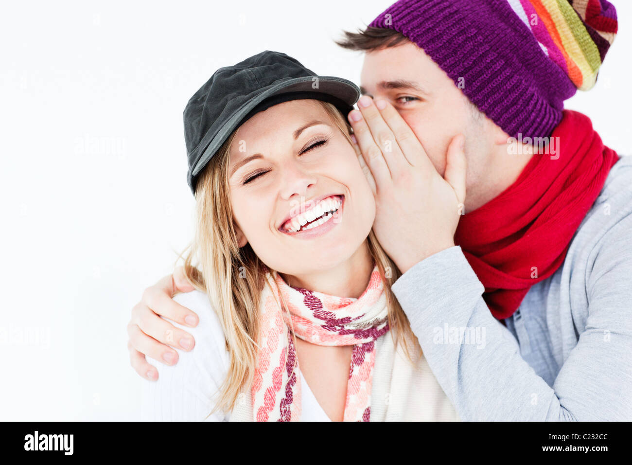 Young couple sharing a secret Stock Photo - Alamy