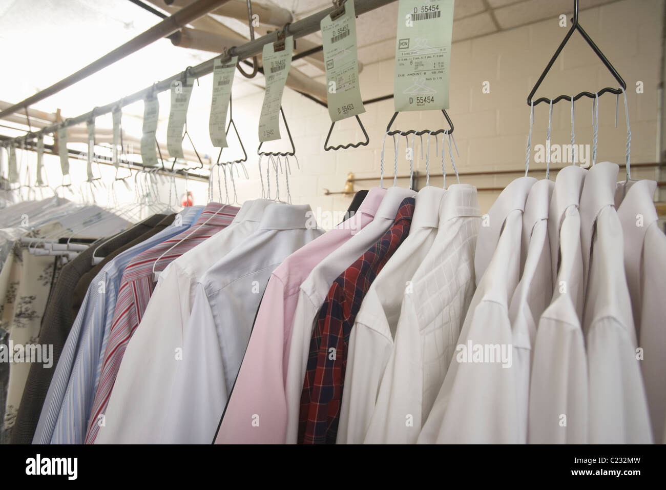 Clothes hanging in the laundrette Stock Photo - Alamy