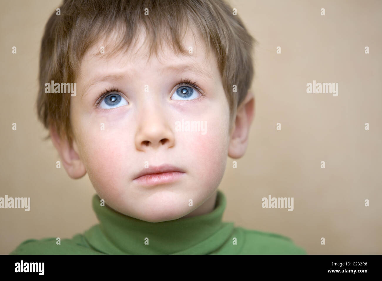 Portrait young boy gazing upwards Stock Photo - Alamy