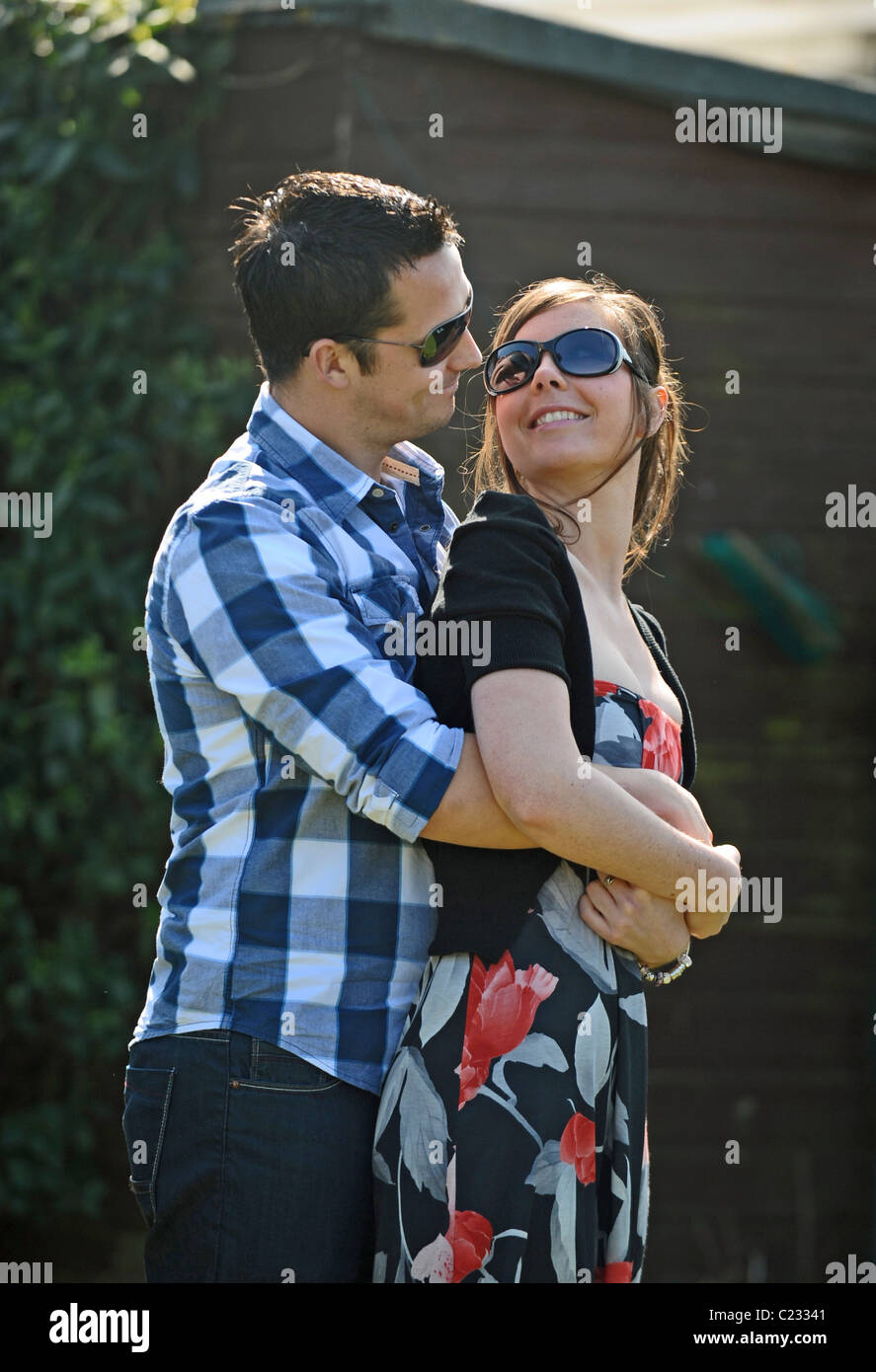 Young couple in their twenties 20s age group kissing and cuddling in ...