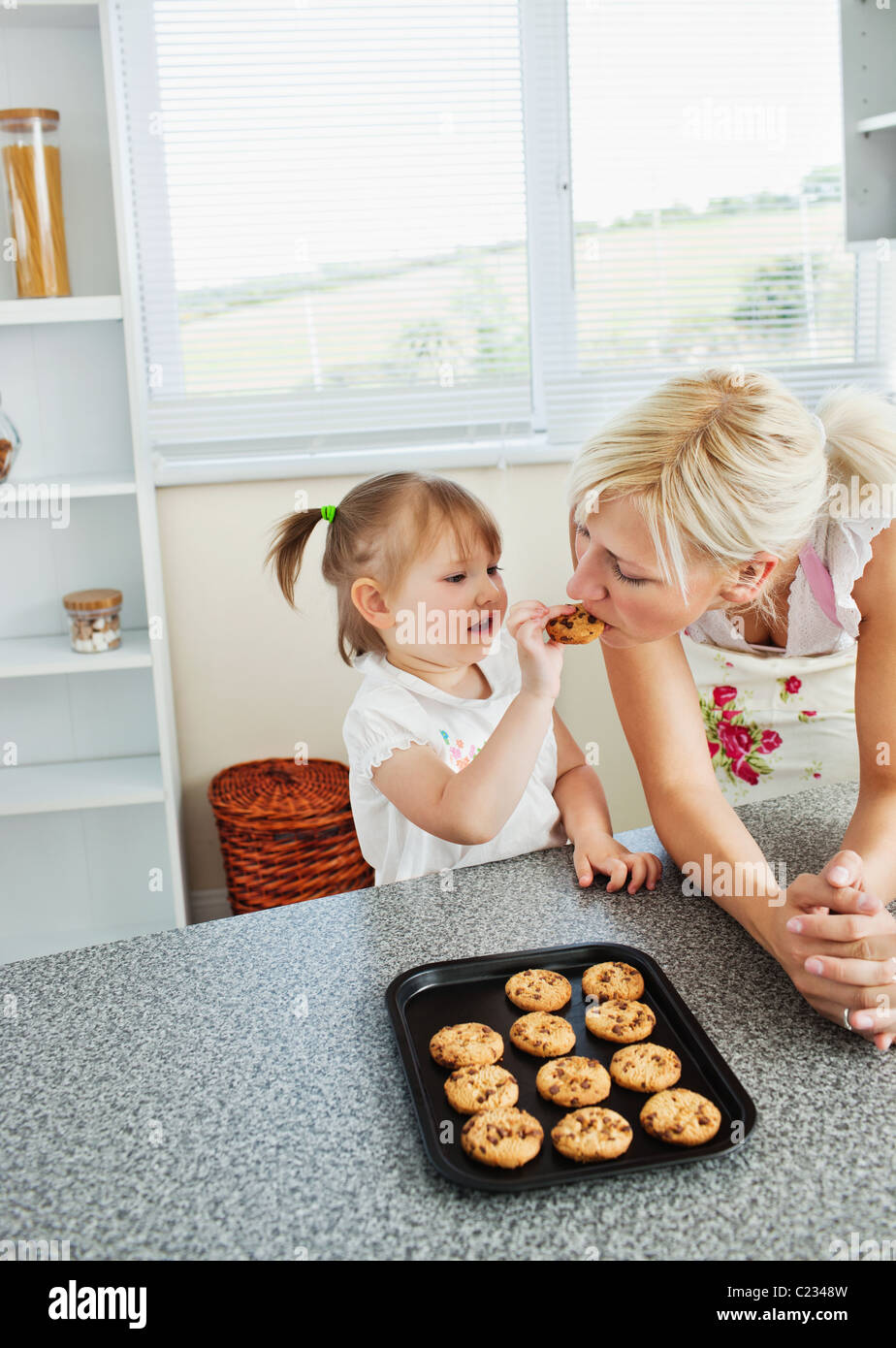 Pretty mother baking cookies with her daughter Stock Photo - Alamy