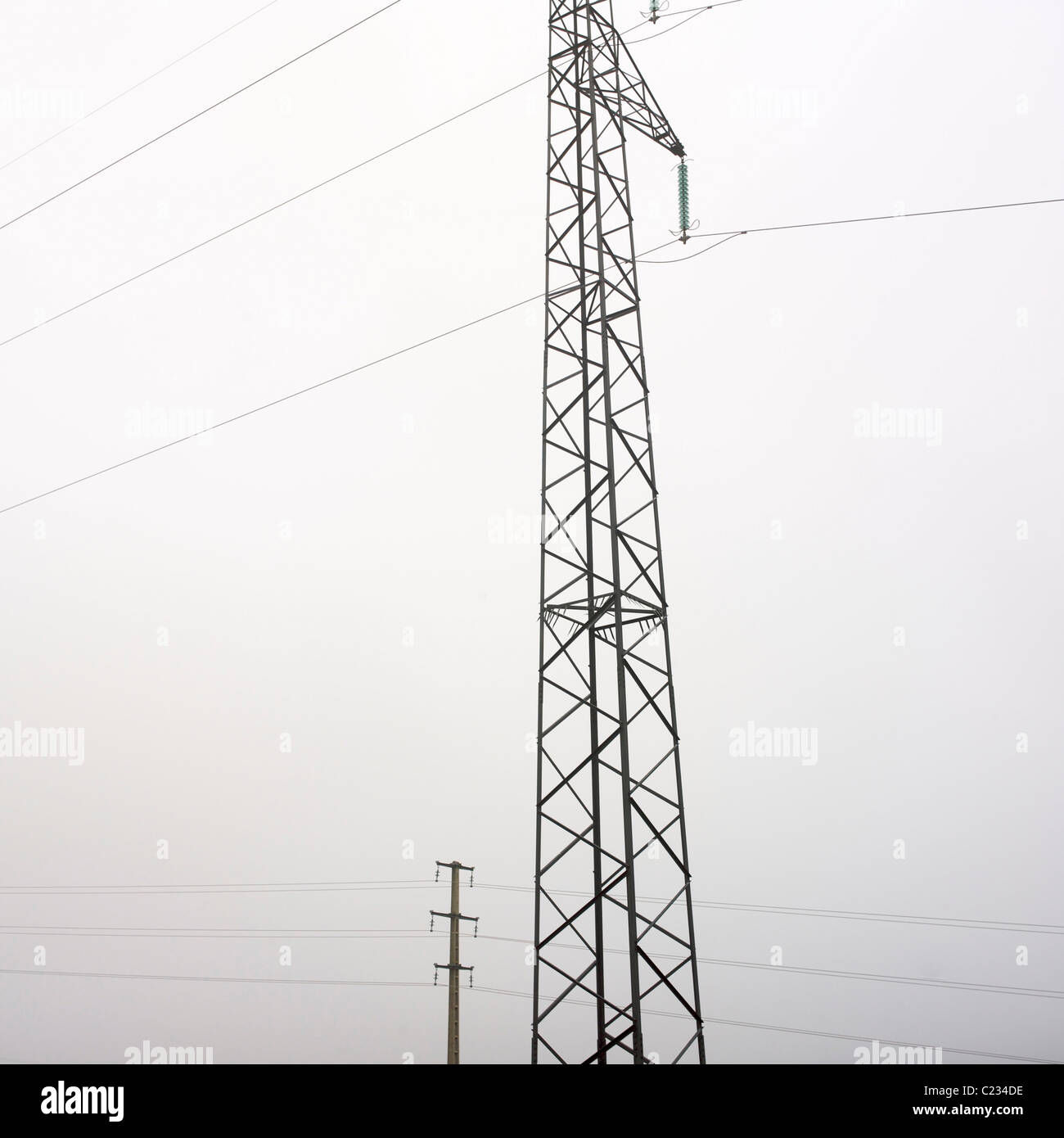 Power transmission tower rising against a clear sky shows electrical ...