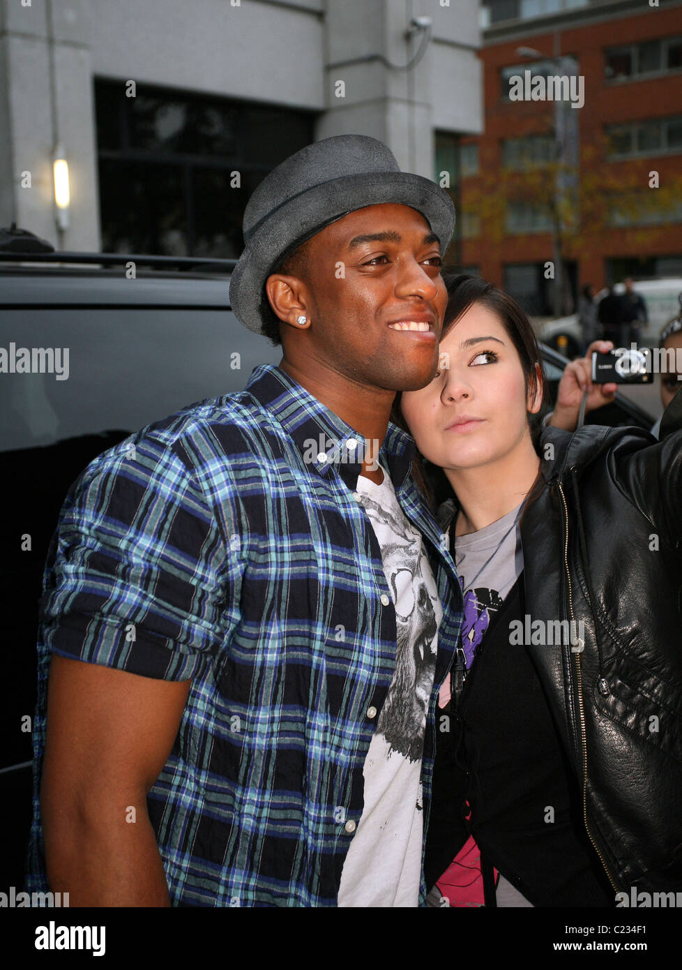 Ortise Williams of JLS poses for a picture with a fan outside the GMTV ...