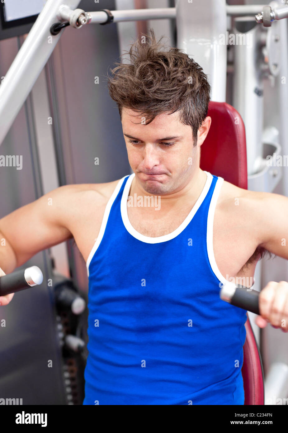 Gorgeous man working hard on a bench press in a fitness centre Stock ...