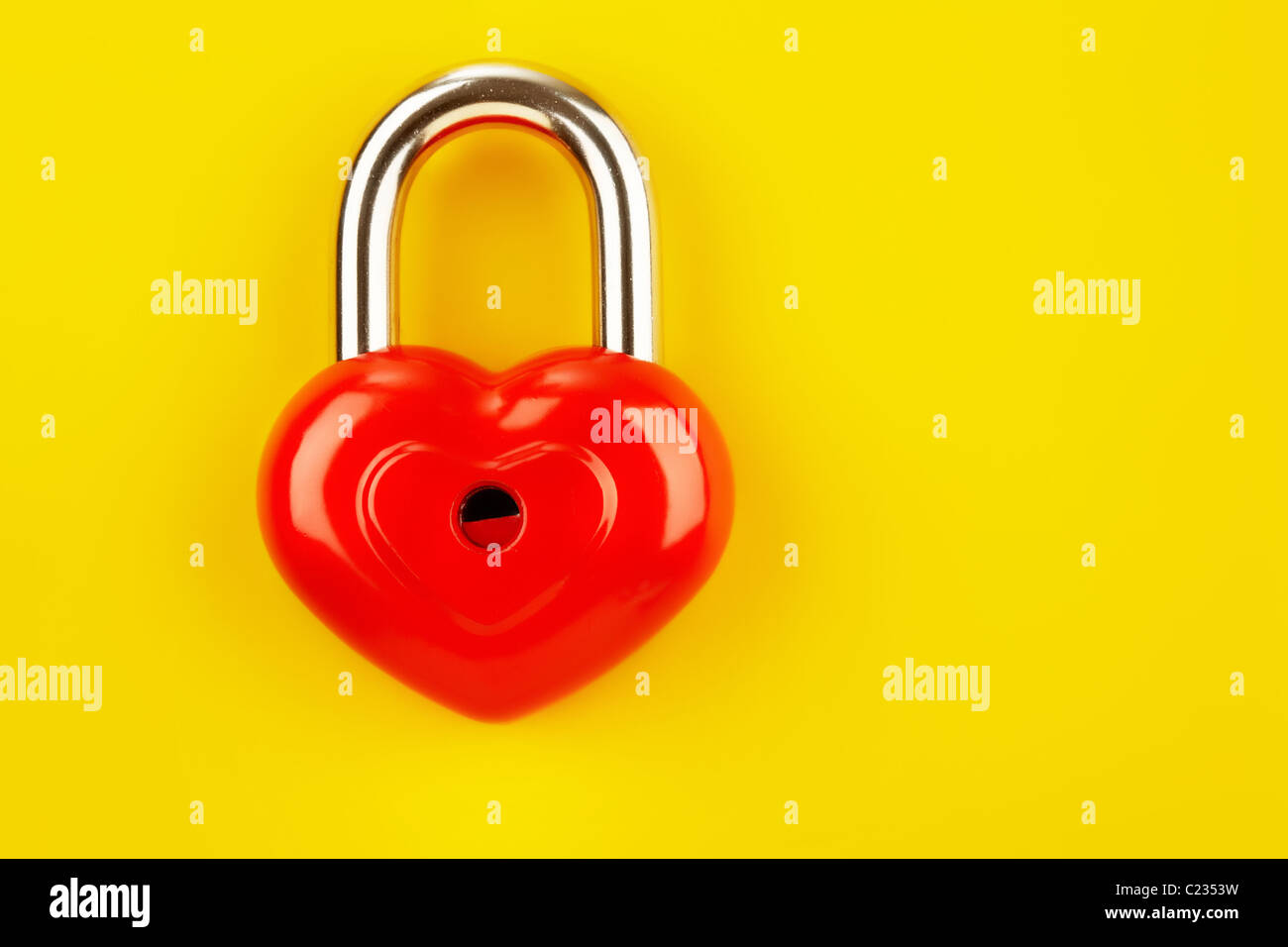 Image of red lock on a yellow background Stock Photo - Alamy