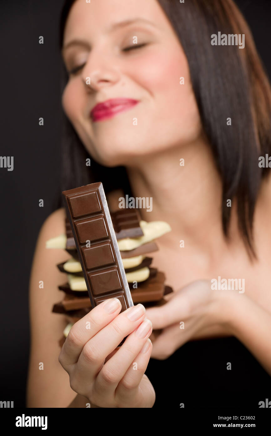 Chocolate - portrait of healthy woman enjoy sweets on black background ...