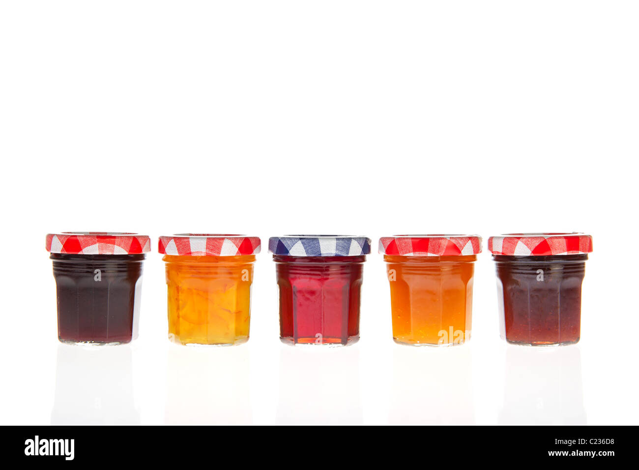 Five various pots of jam on white background Stock Photo - Alamy