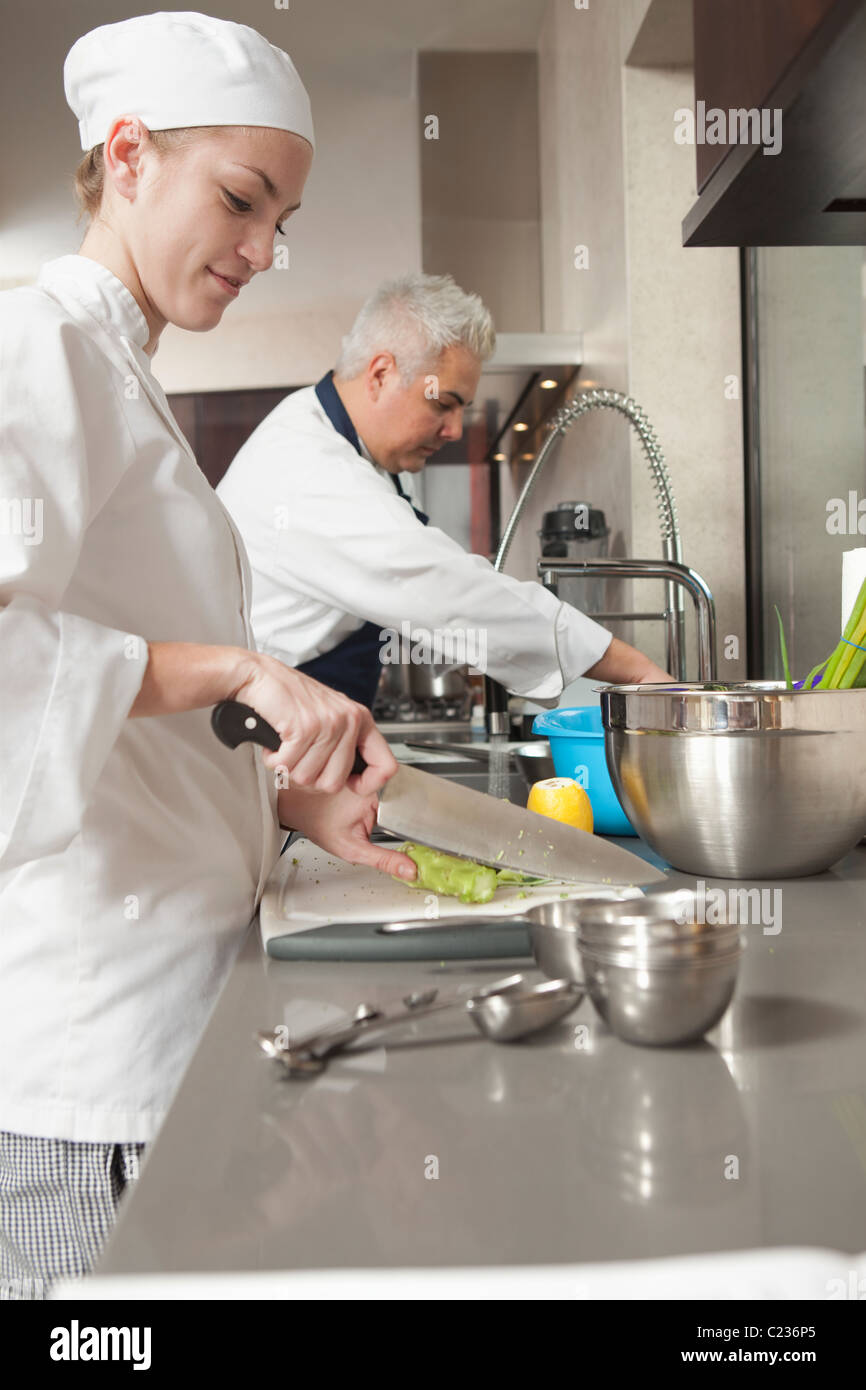 Young chef chopping Stock Photo - Alamy
