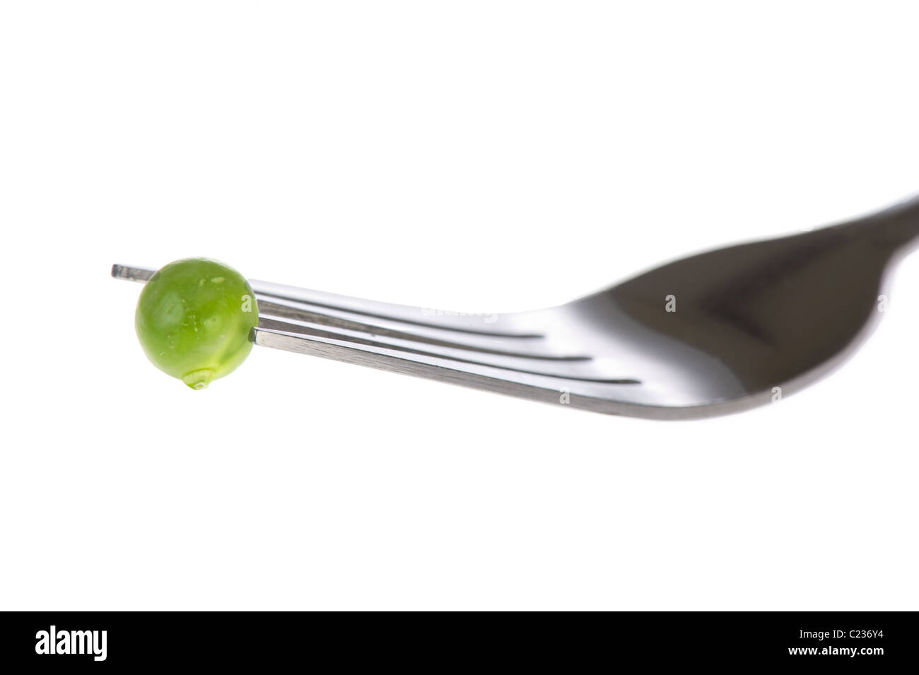 Single green pea on a fork isolated over whote background Stock Photo ...
