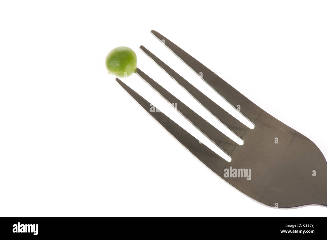 Single green pea on a fork isolated over whote background Stock Photo ...