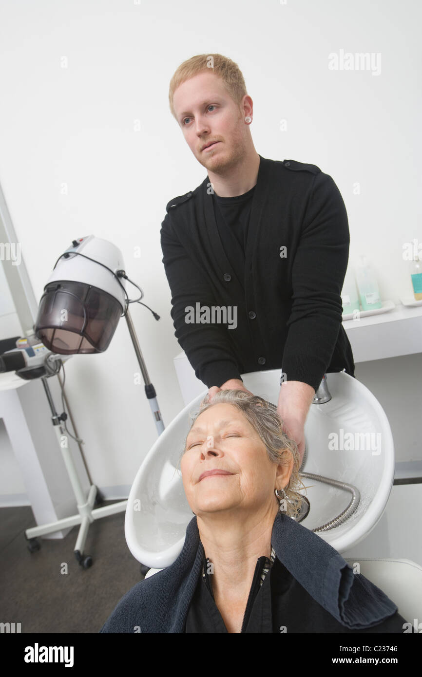 Shampooing hair in salon basin Stock Photo - Alamy
