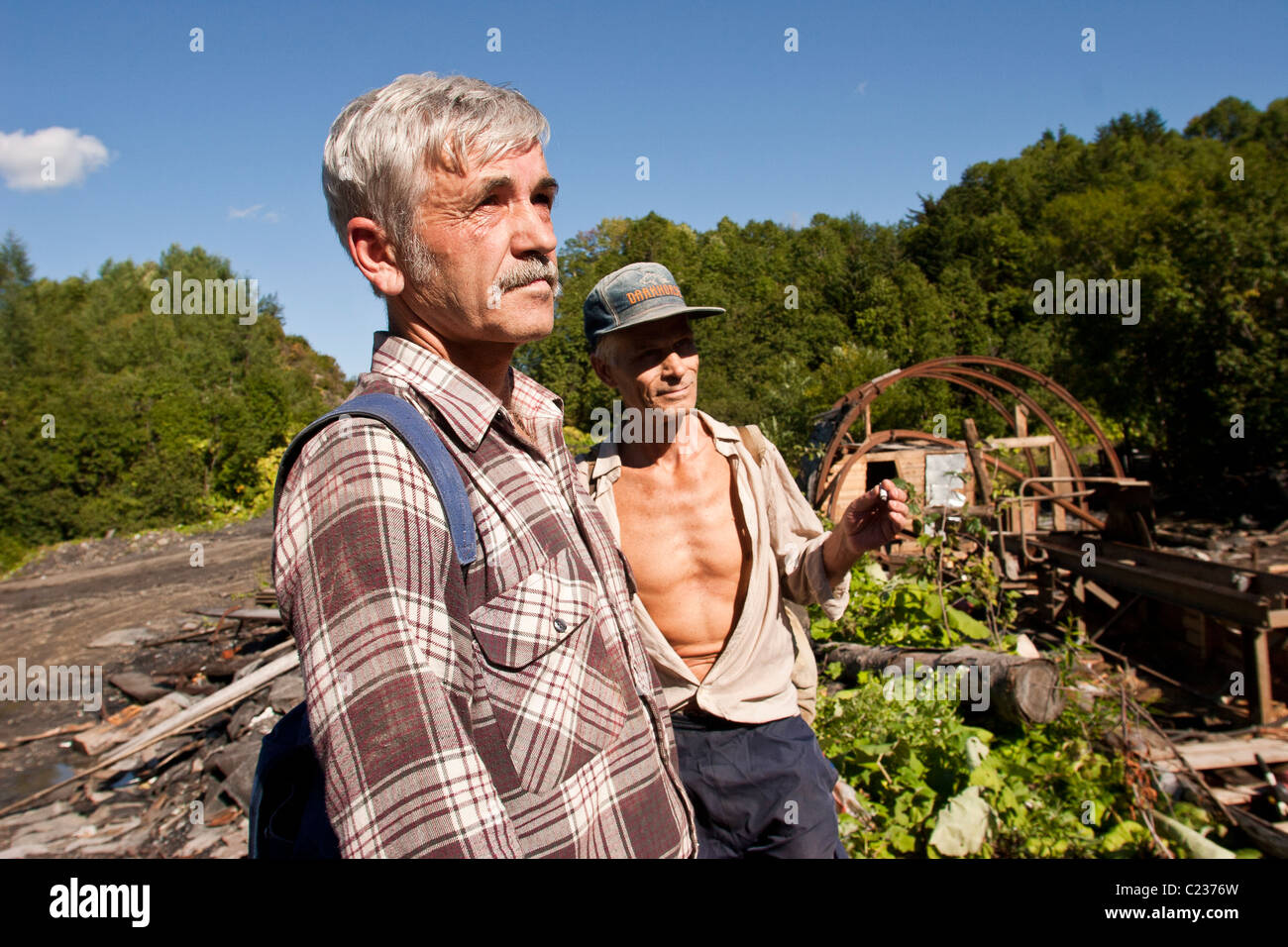 Ex miners are seen near an abandoned mine in Sinegorsk, Sakhalin ...