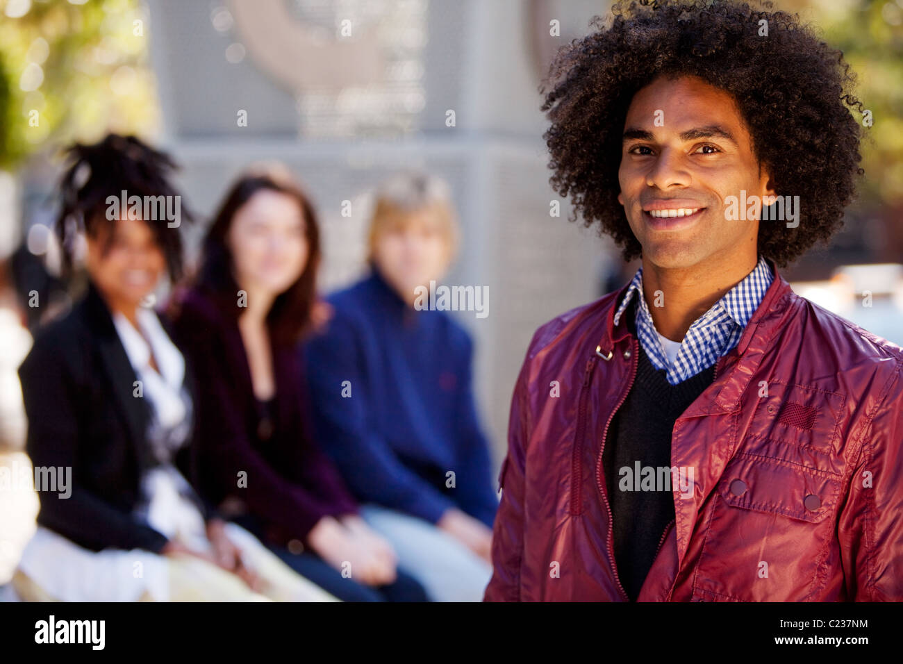 Group of four people of different ethnicities with one man as focus of ...