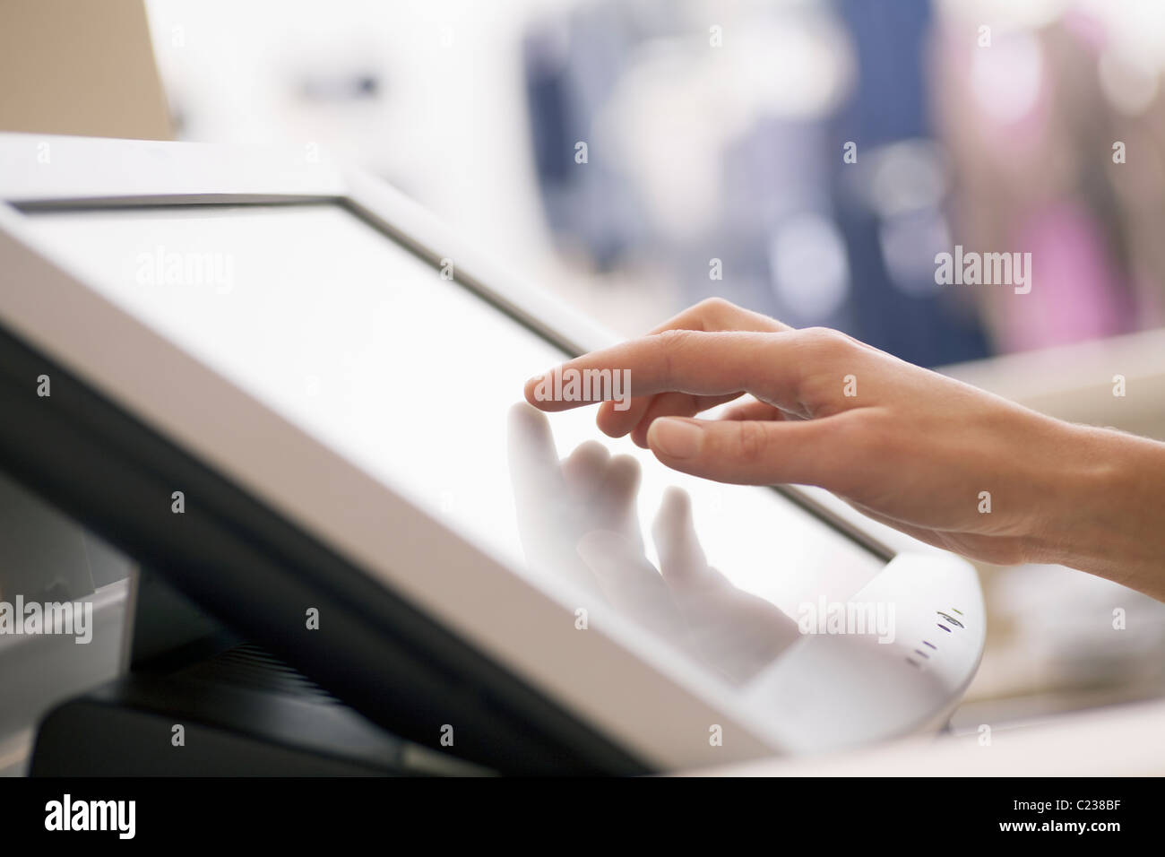 Ladys hand touching a touch screen till Stock Photo - Alamy